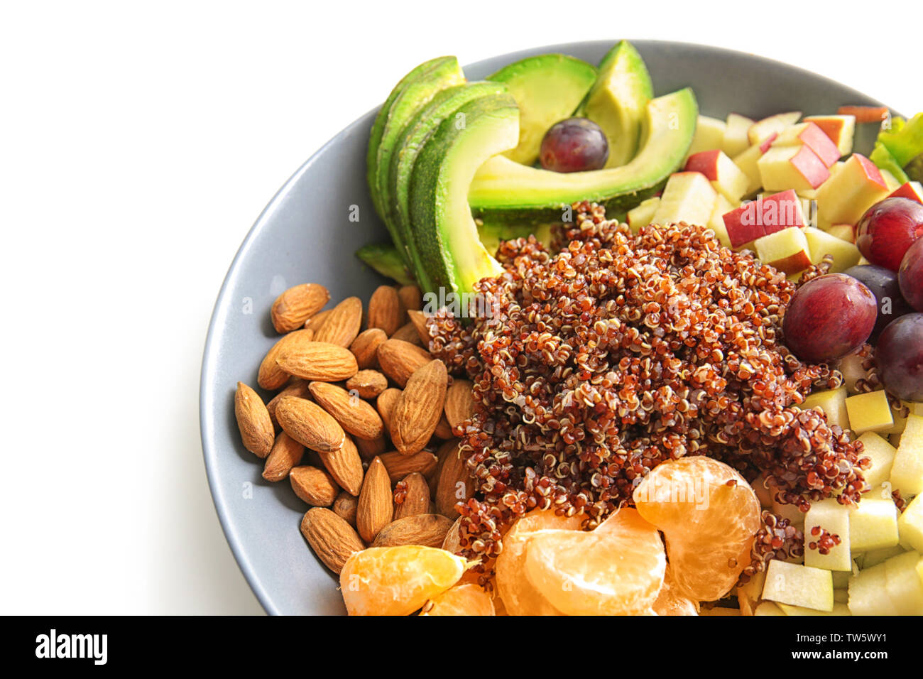 Plate with quinoa, fruits and almonds on white background Stock Photo ...