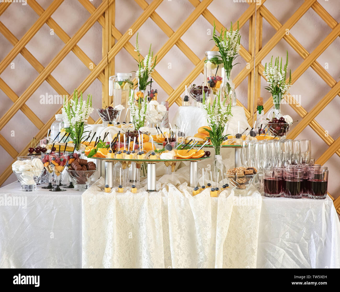 Wedding buffet table with different fruit desserts and drinks indoors ...