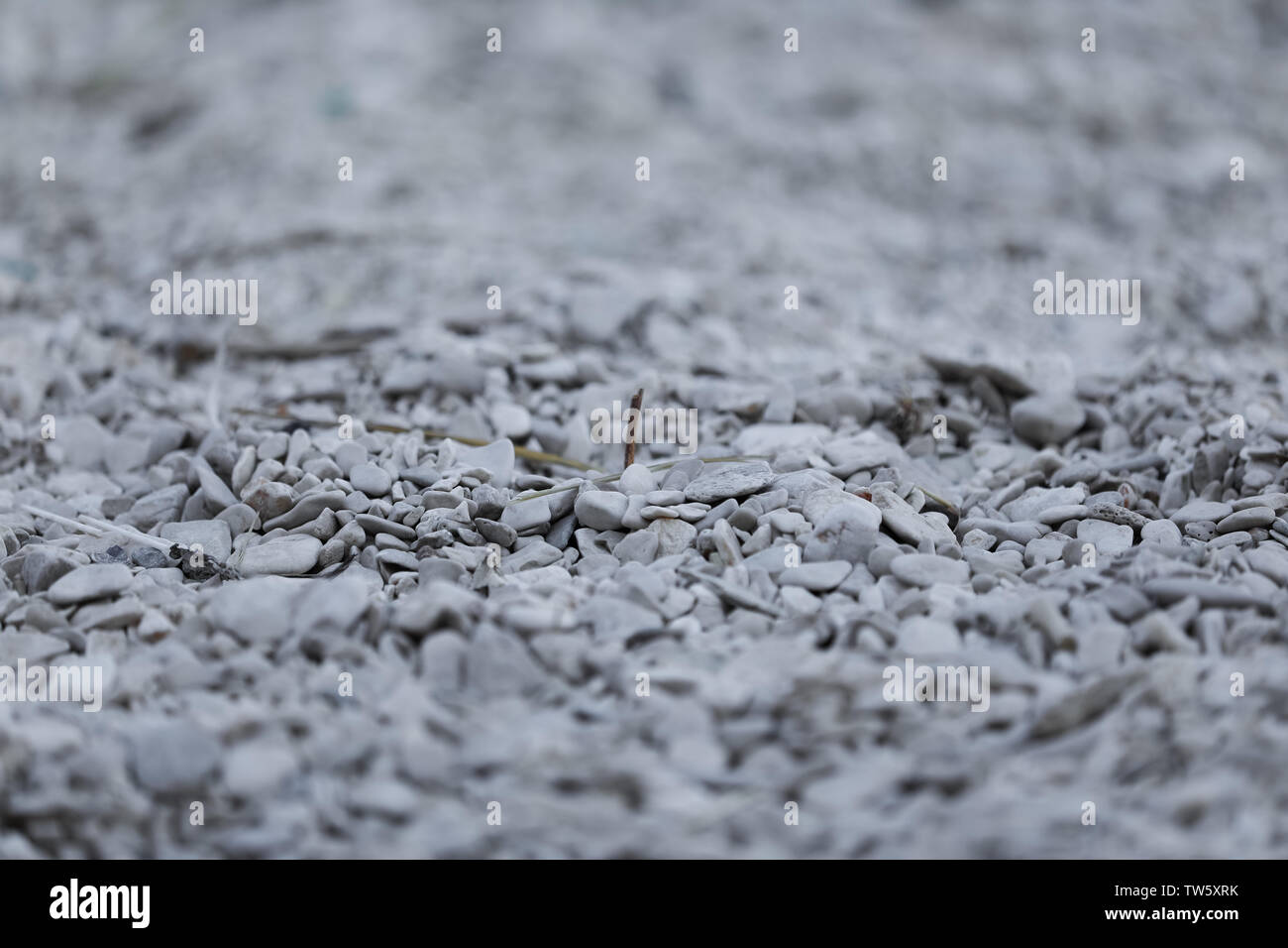 Small gray stones with diffused background Stock Photo - Alamy
