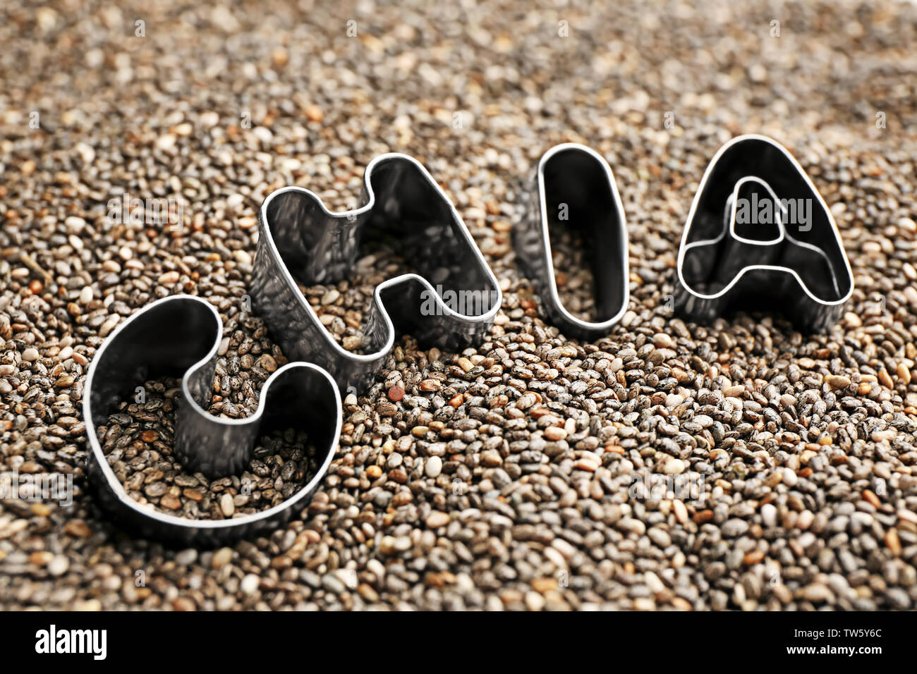 Letters on chia seeds, closeup Stock Photo - Alamy