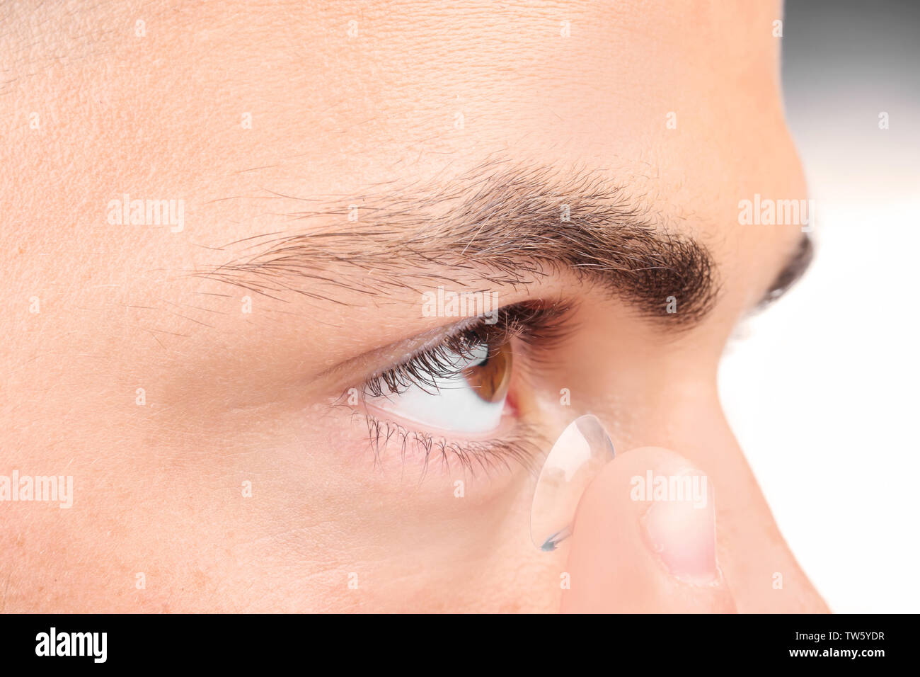 Man wearing contact lens eye hi-res stock photography and images - Alamy