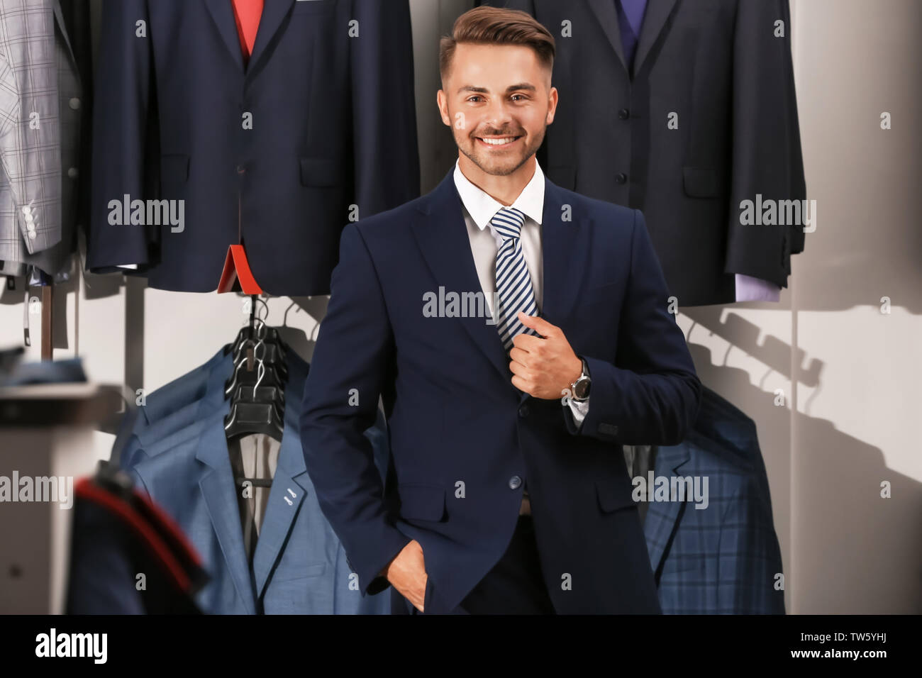 Handsome man in luxury suit store Stock Photo - Alamy