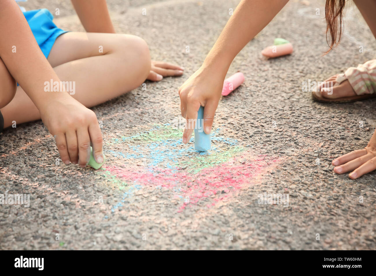 Children drawing with chalk on asphalt, outdoors Stock Photo - Alamy