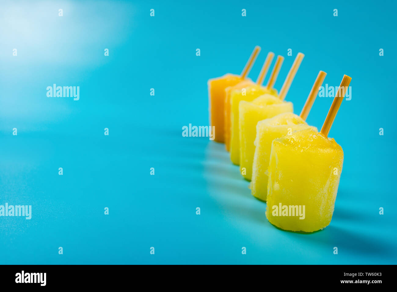 mini size popsicles stand on a blue background with copy space Stock ...