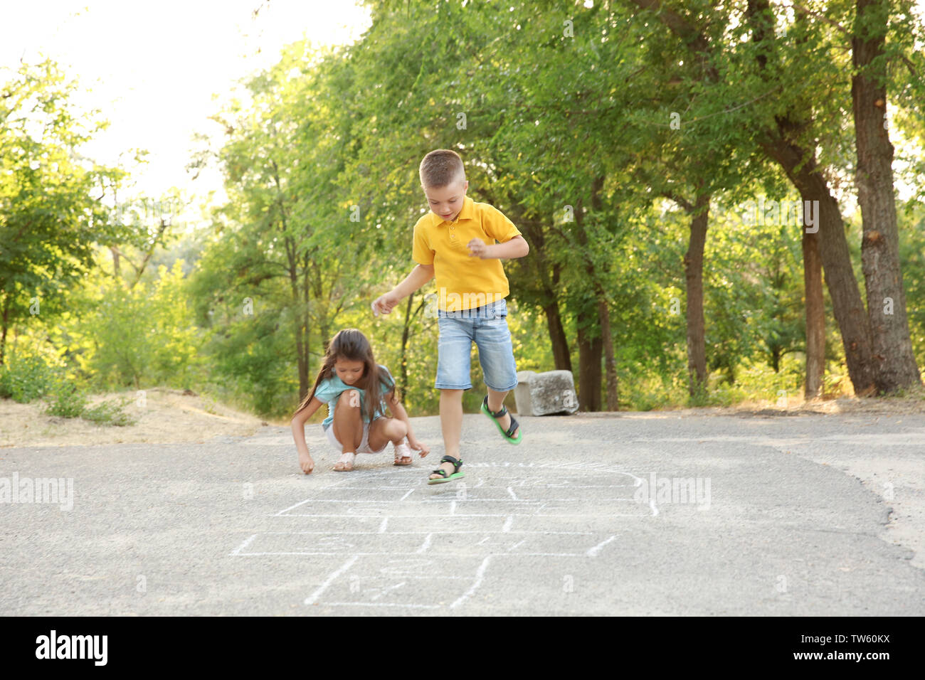 Cute little children playing hopscotch, outdoors Stock Photo - Alamy