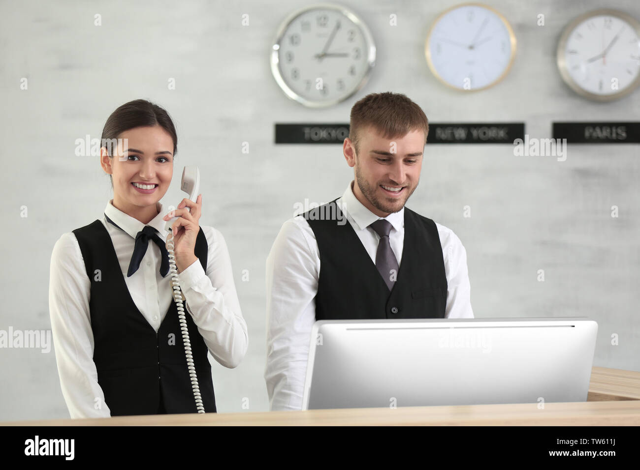 Two hotel receptionists at work Stock Photo - Alamy