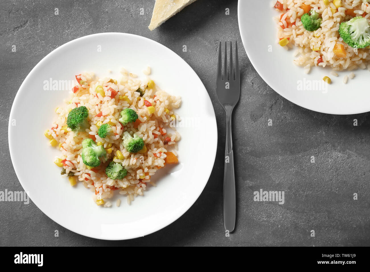 Plates with rice pilaf and broccoli on table Stock Photo - Alamy