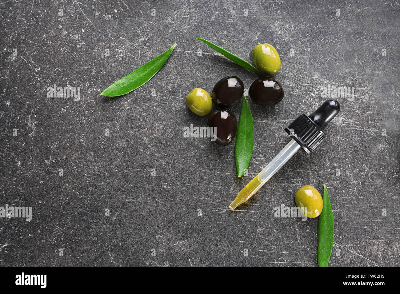 Pipette with olive oil on dark background Stock Photo - Alamy