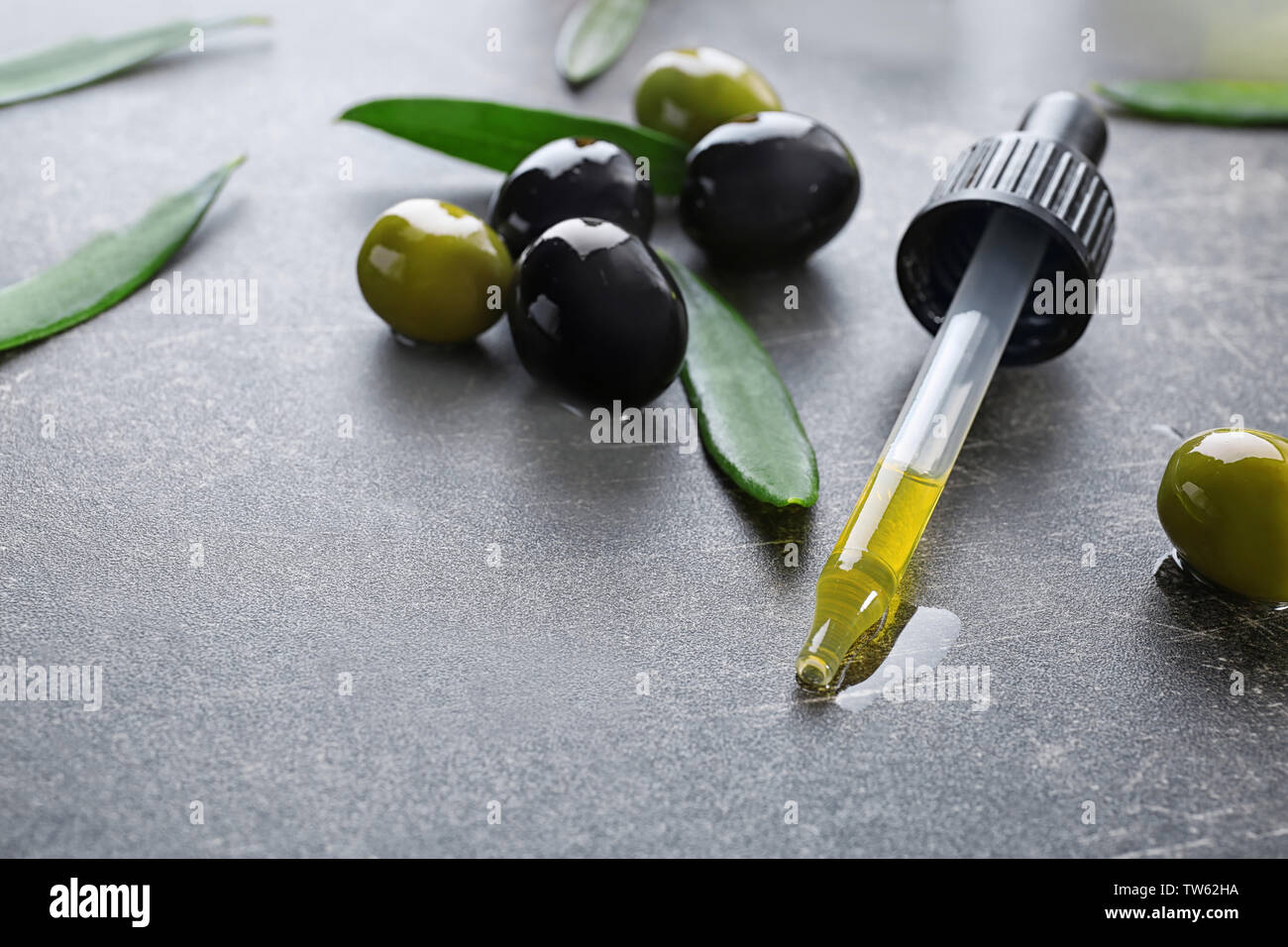 Pipette with olive oil on dark background Stock Photo - Alamy