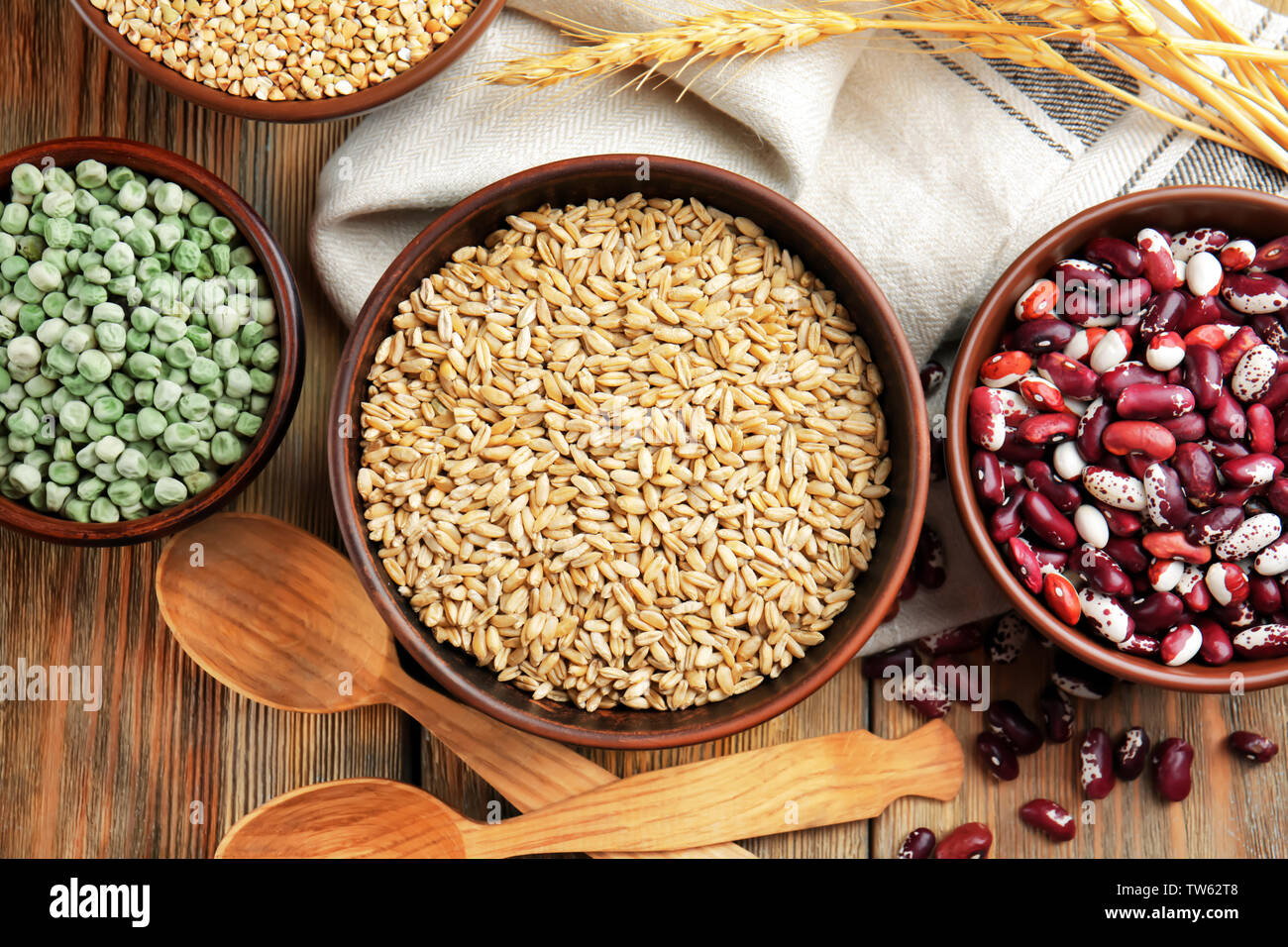 Bowls with different grains on kitchen table Stock Photo - Alamy