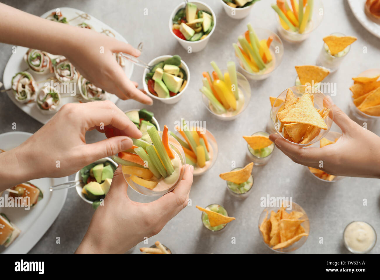 Buffet table woman putting food hi-res stock photography and images - Alamy