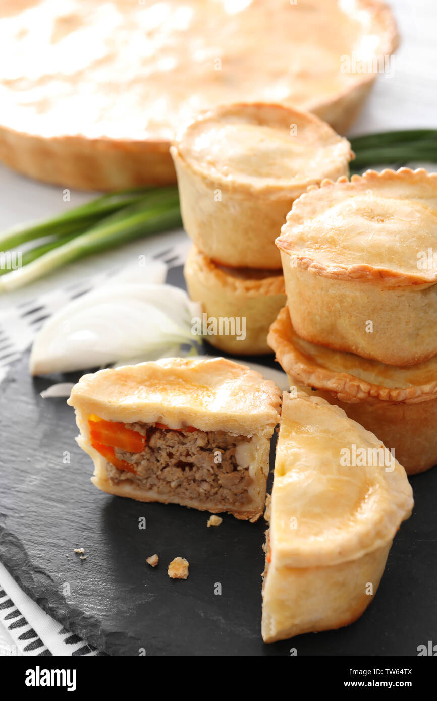 Delicious little meat pies on slate plate Stock Photo - Alamy