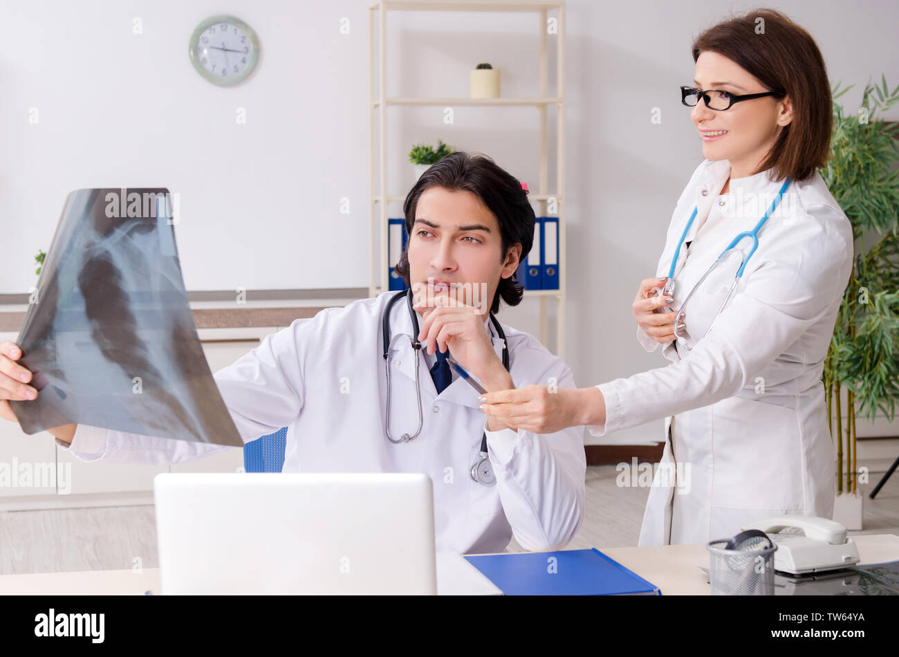 Two doctors working in the clinic Stock Photo - Alamy