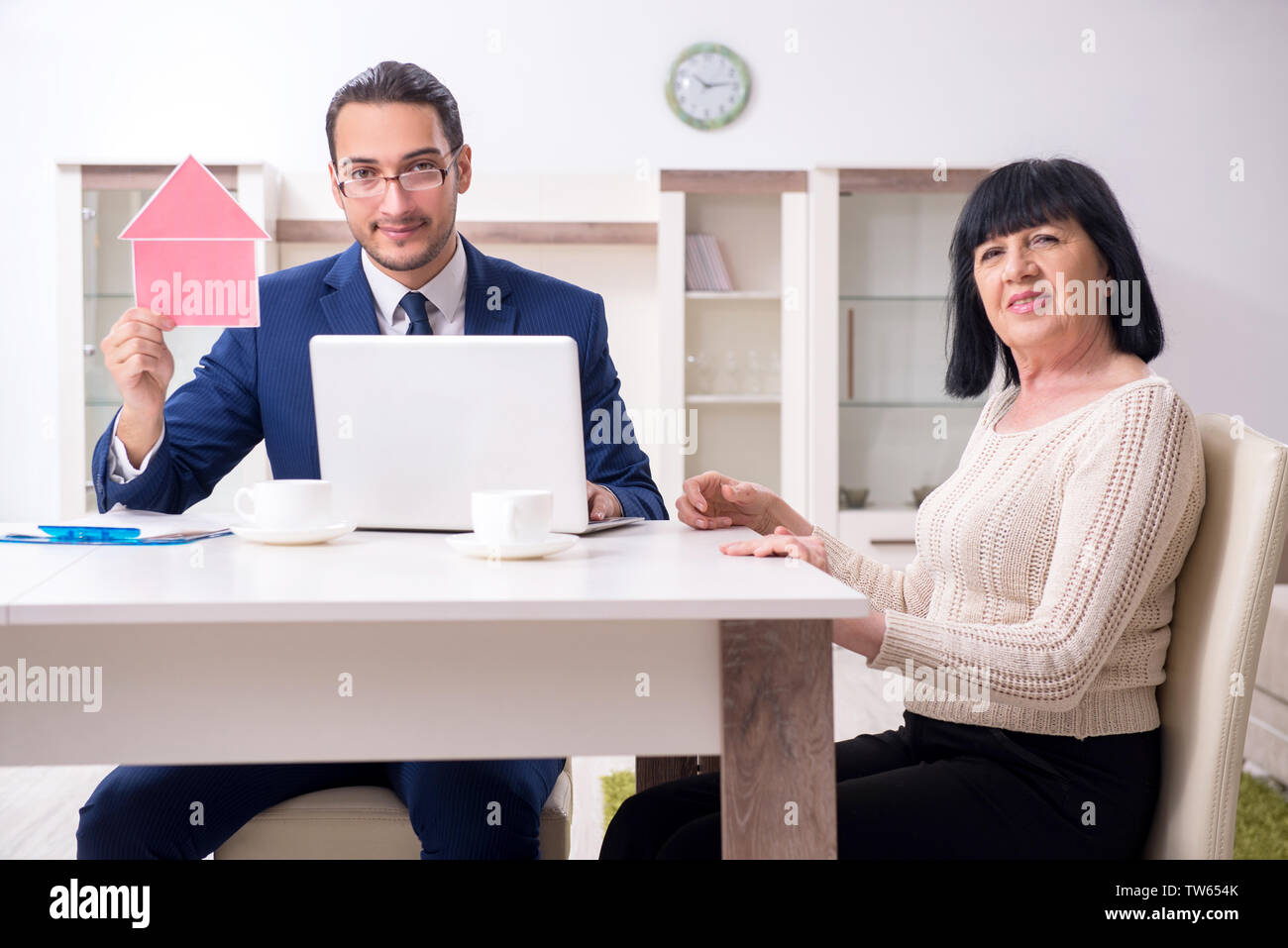 Male real estate agent and female client in the apartment Stock Photo ...