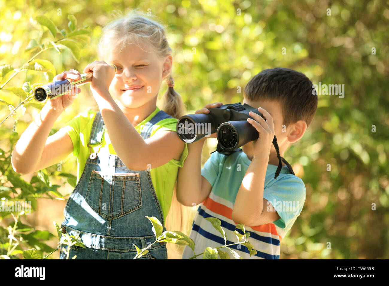 Cute children with binoculars and spyglass outdoors Stock Photo - Alamy