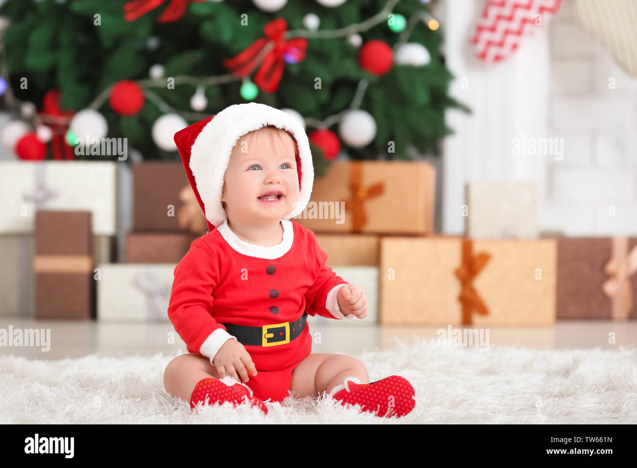 Cute baby in Santa Claus costume at home Stock Photo - Alamy