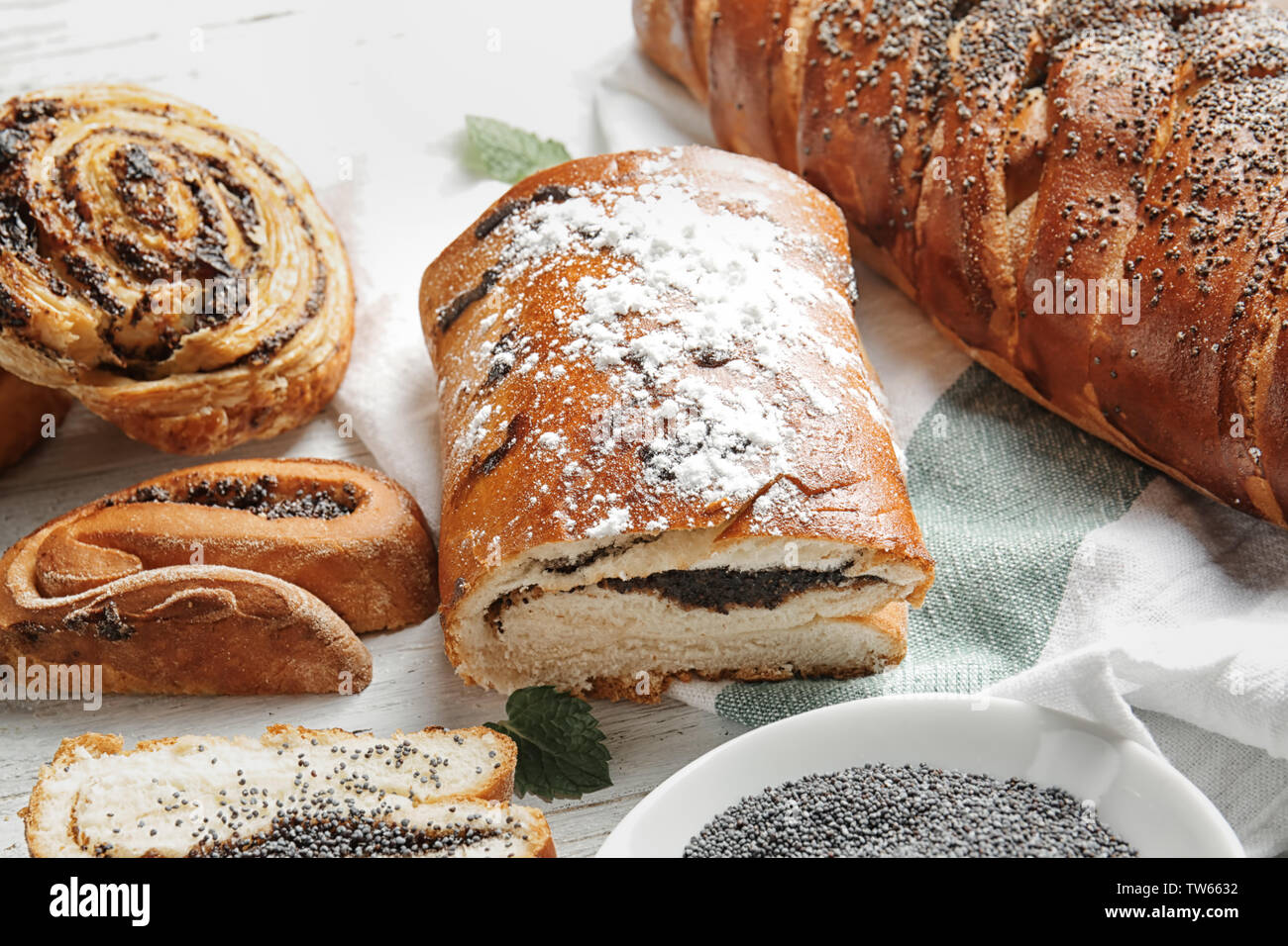 Tasty pastries with poppy seeds on table Stock Photo - Alamy