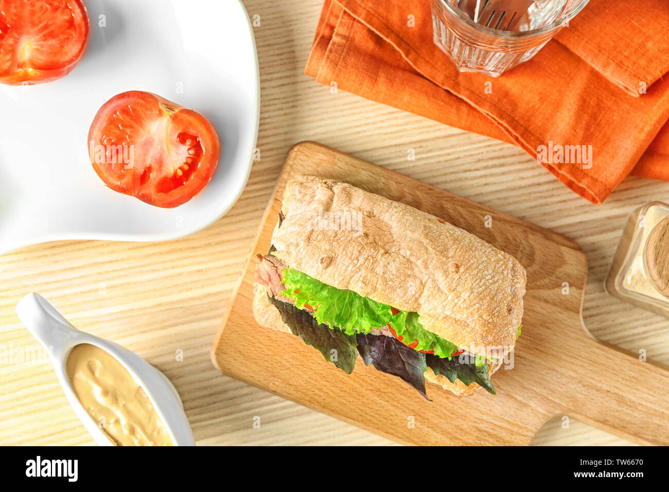Composition with delicious steak sandwich on table Stock Photo - Alamy