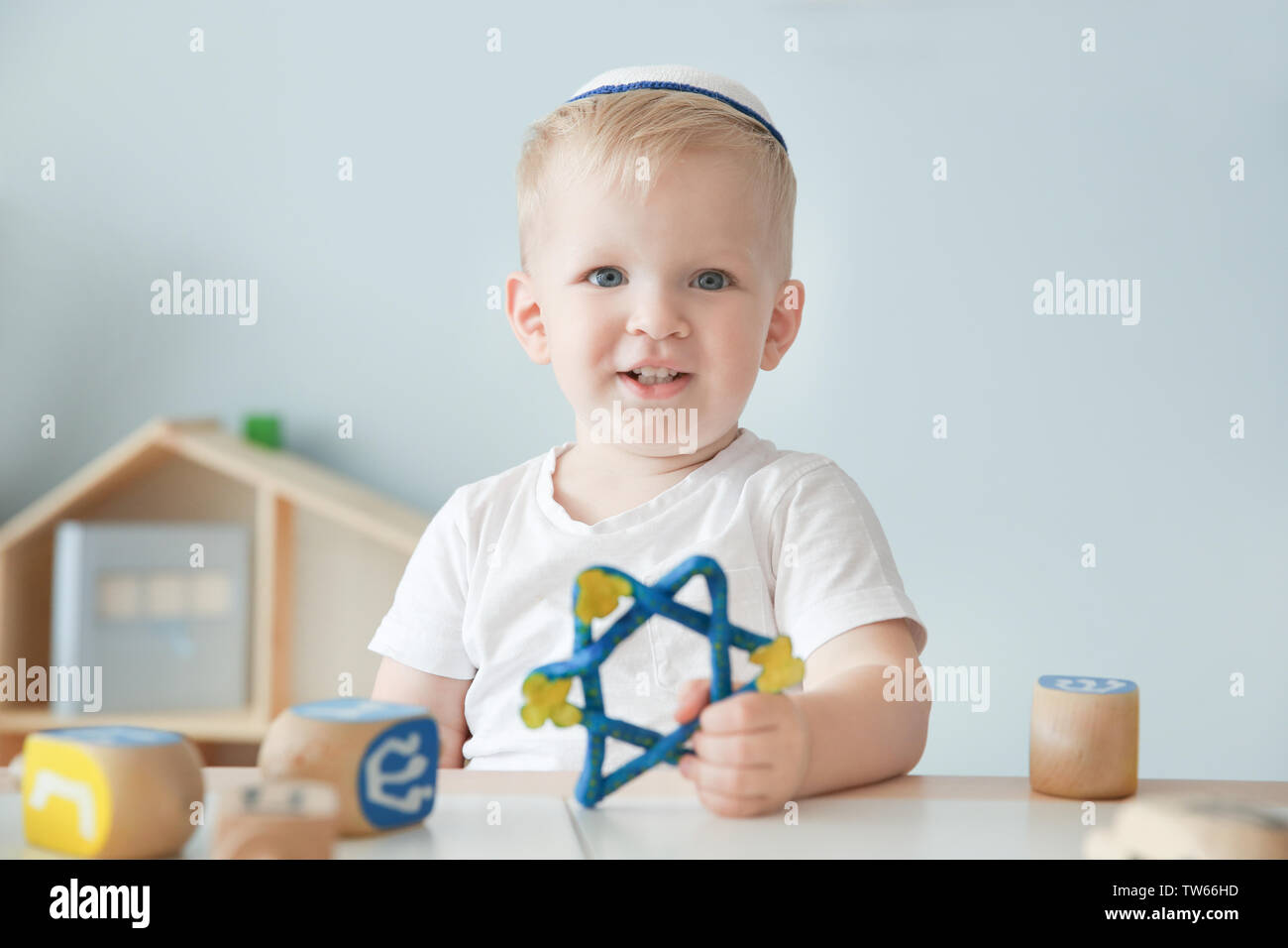 Little Jewish boy with Star of David at home Stock Photo - Alamy