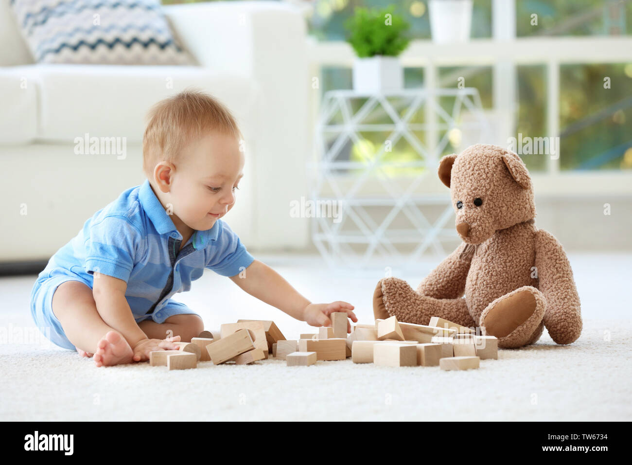 Cute little baby playing at home Stock Photo - Alamy