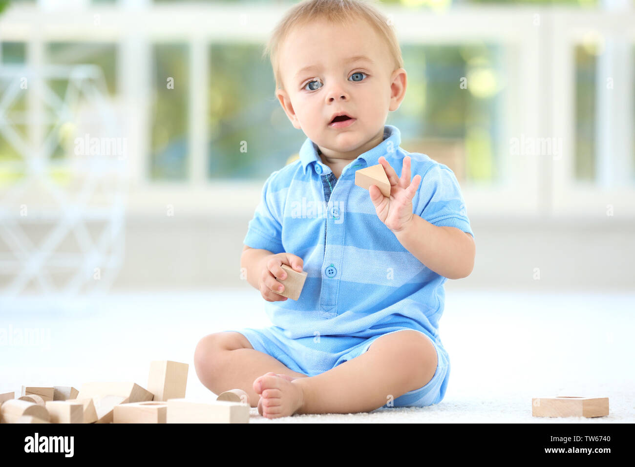 Cute little baby playing at home Stock Photo - Alamy