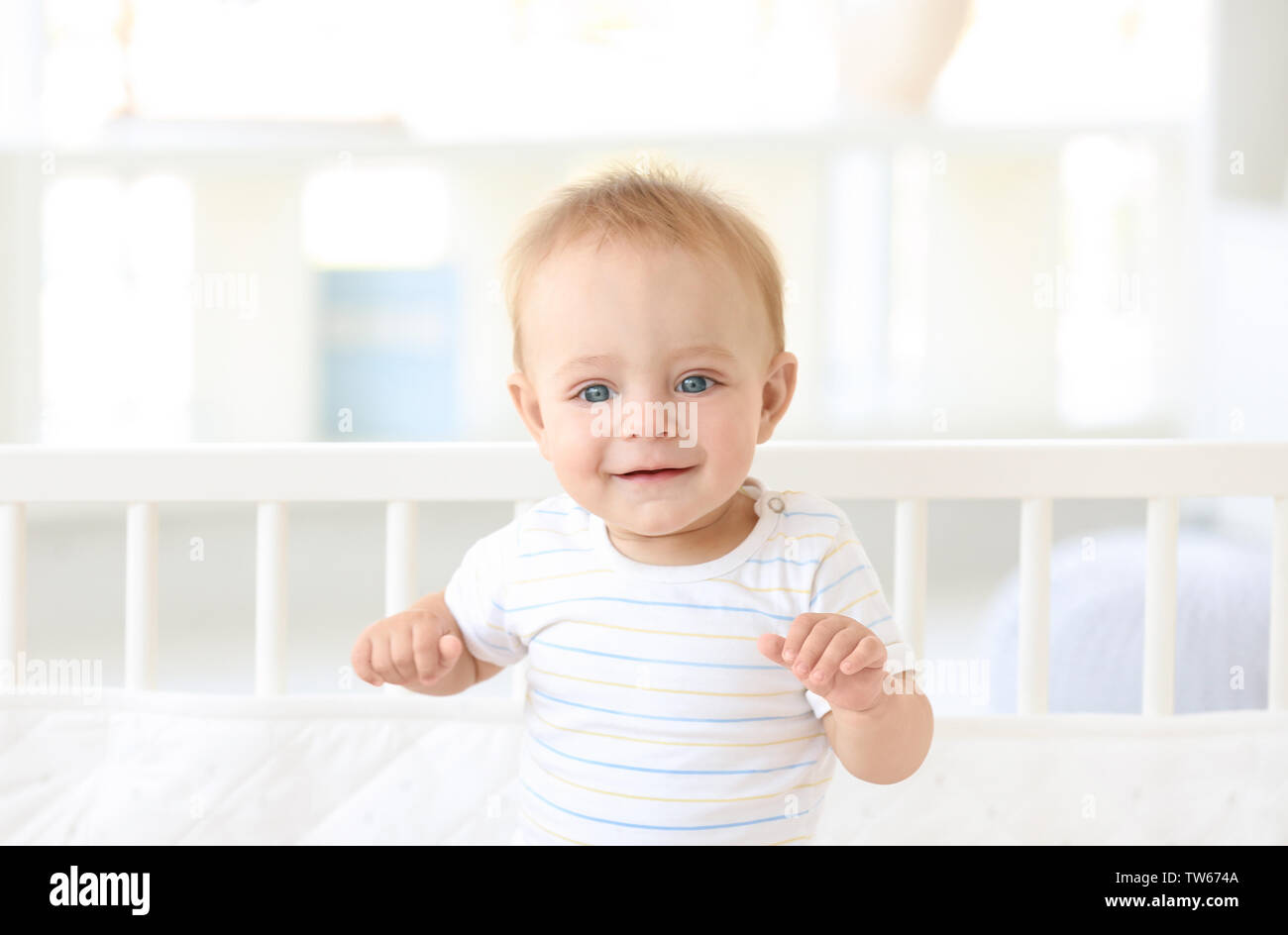 Cute little baby in crib at home Stock Photo - Alamy