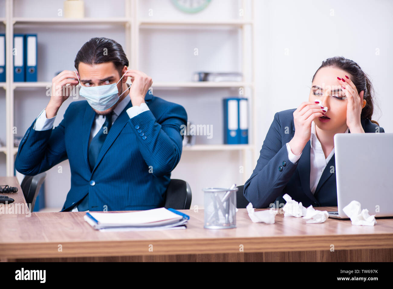 Two employees suffering at workplace Stock Photo - Alamy