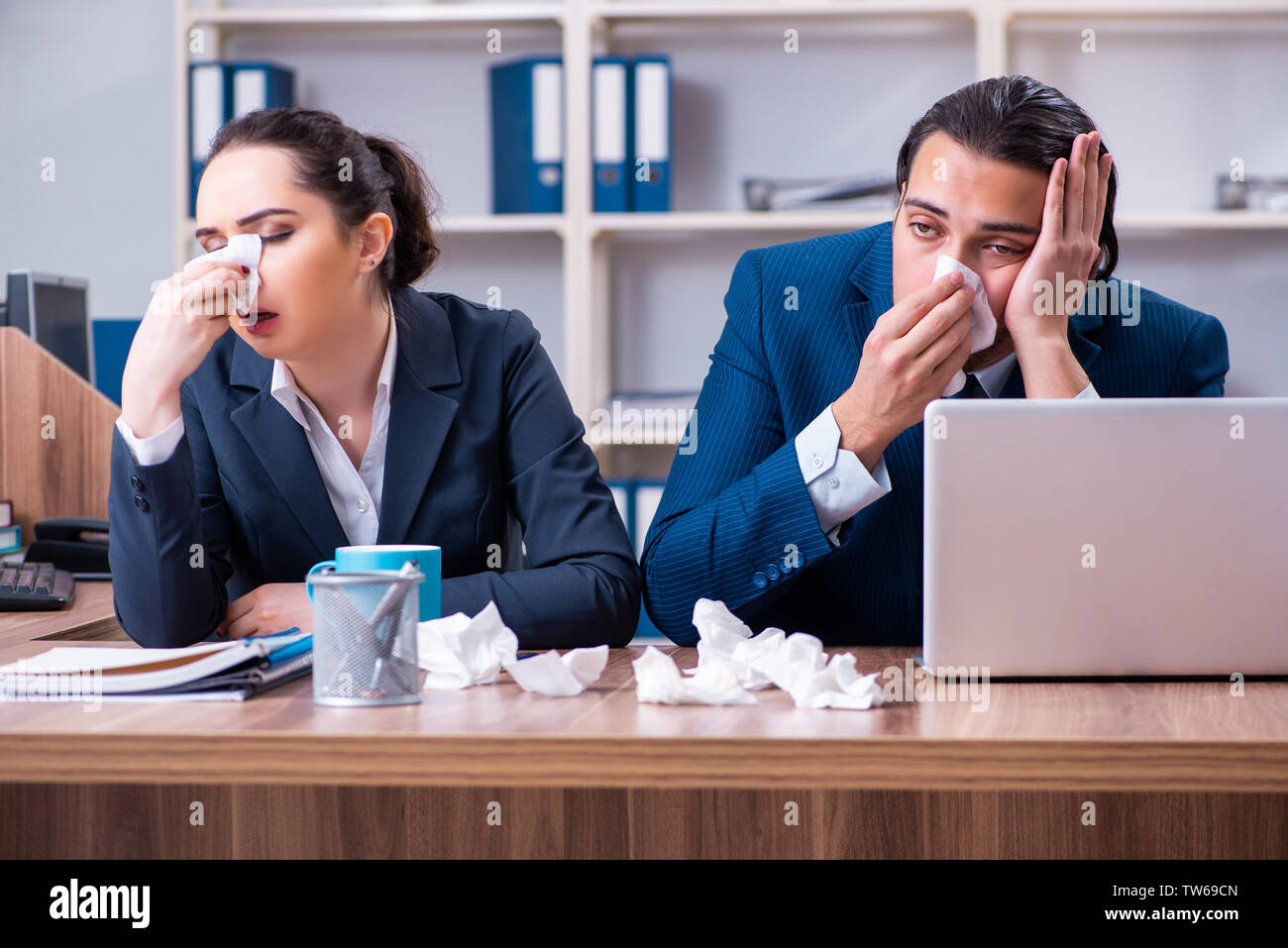 Two employees suffering at workplace Stock Photo - Alamy