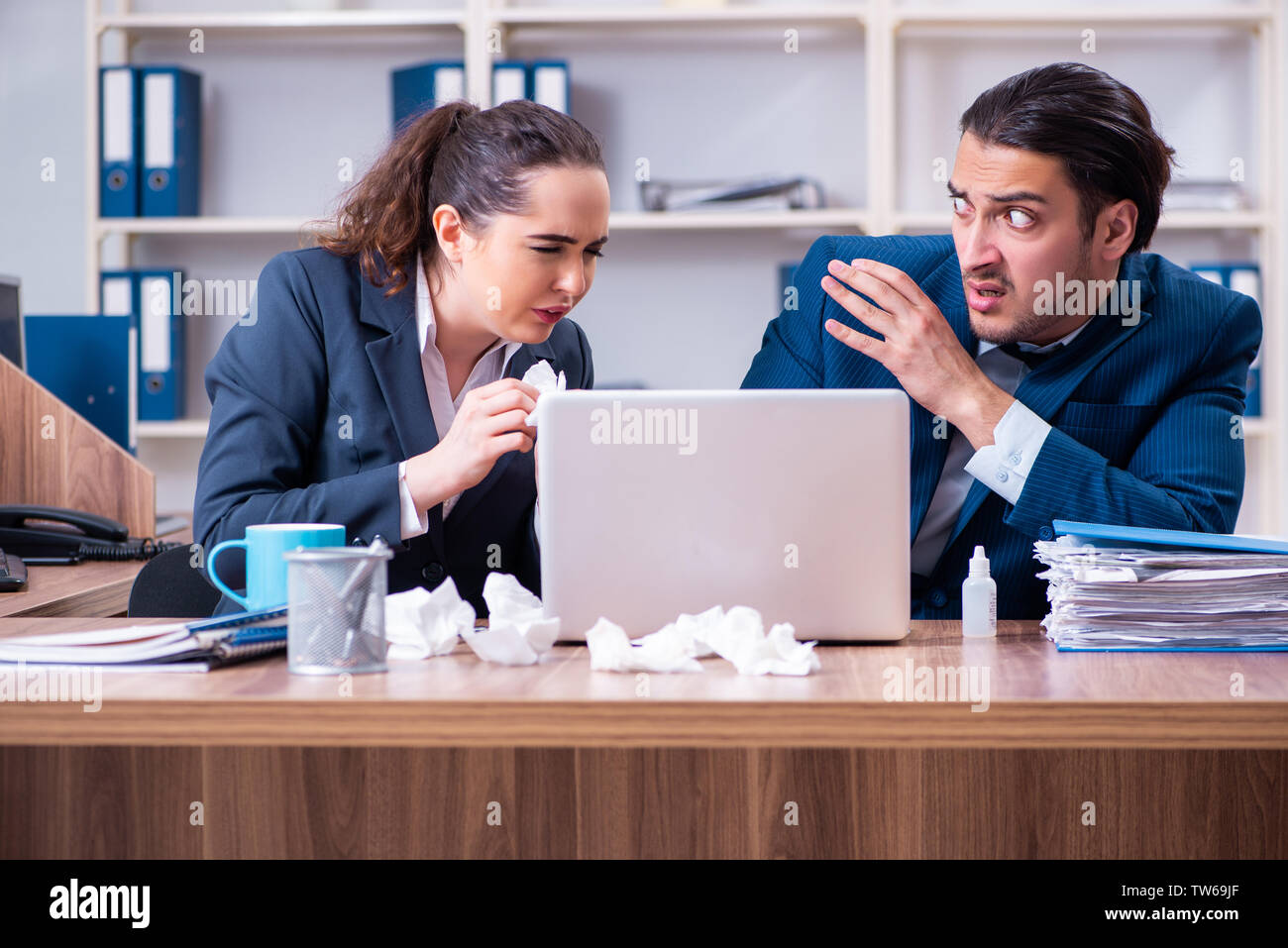 Two employees suffering at workplace Stock Photo - Alamy