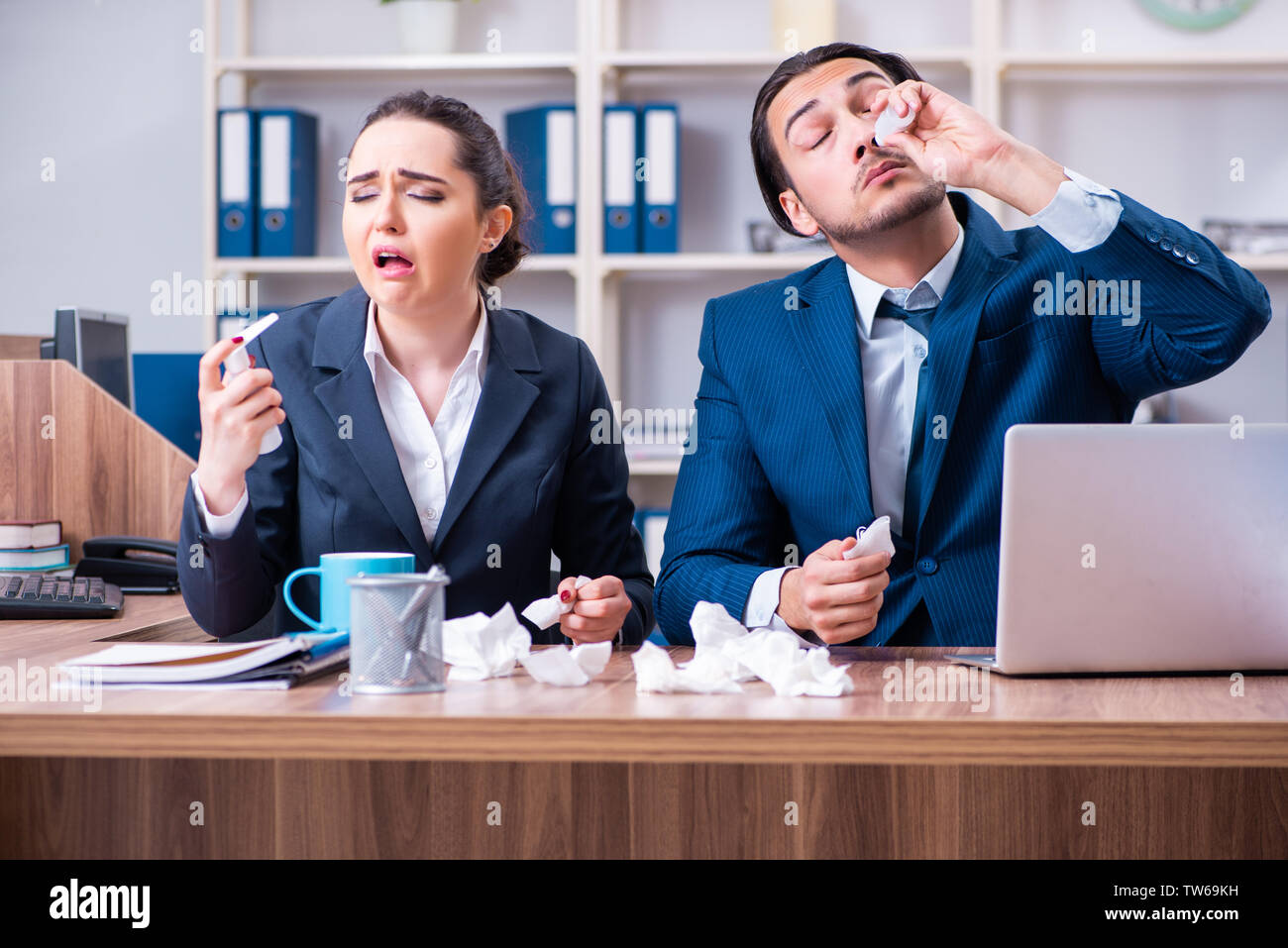 Two employees suffering at workplace Stock Photo - Alamy