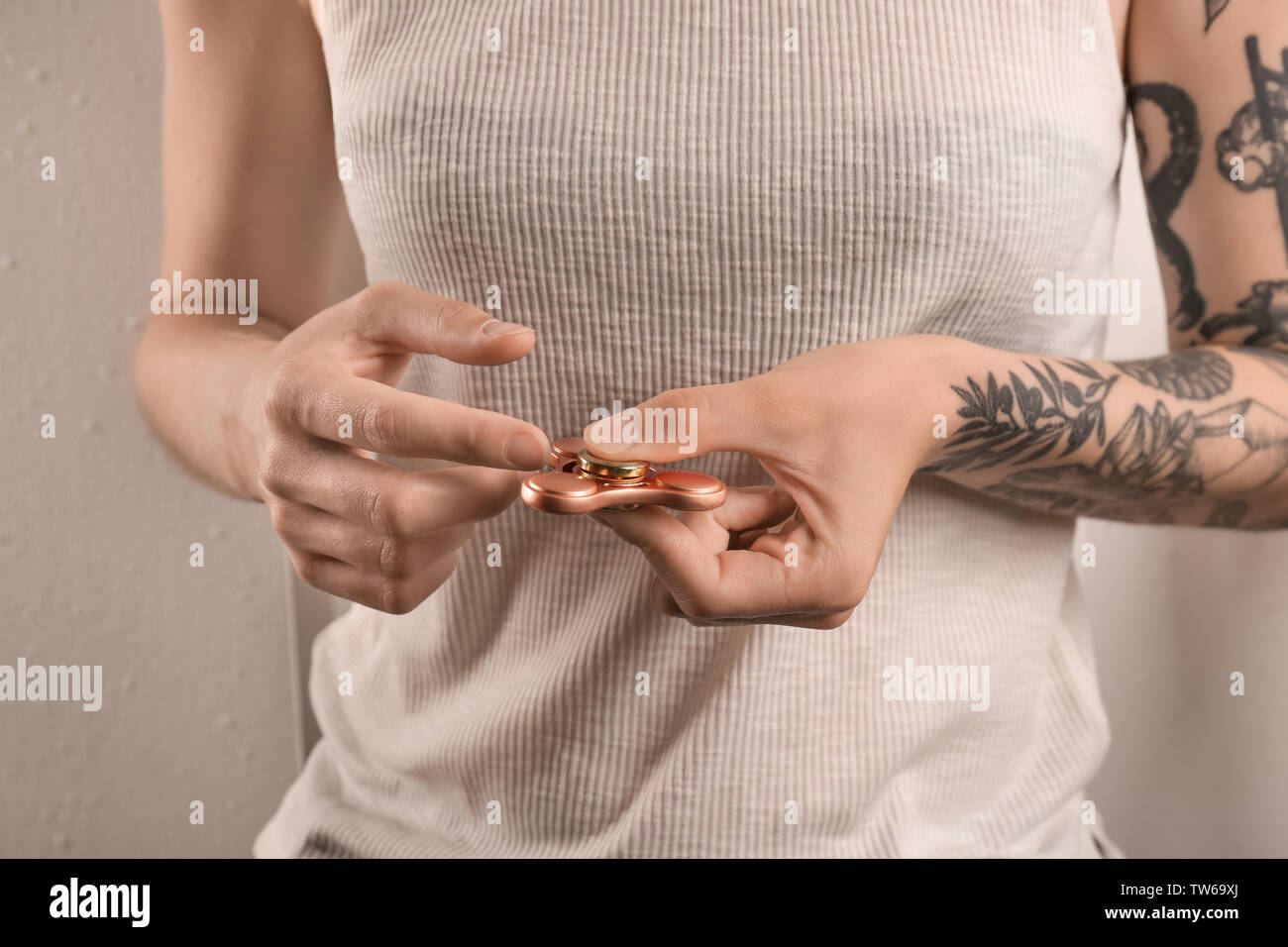 Woman rolling modern spinner indoors Stock Photo - Alamy