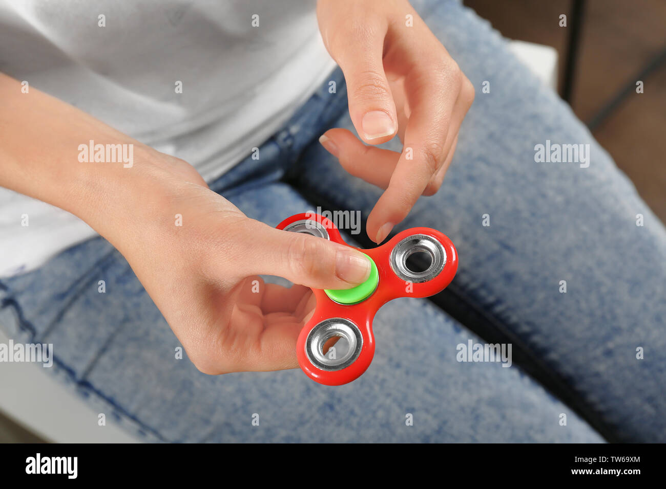 Woman rolling modern spinner indoors Stock Photo - Alamy