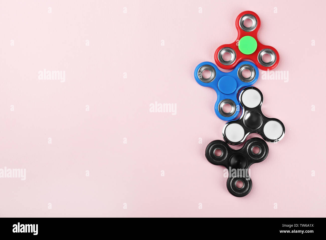 Different modern spinners on color background, top view Stock Photo - Alamy