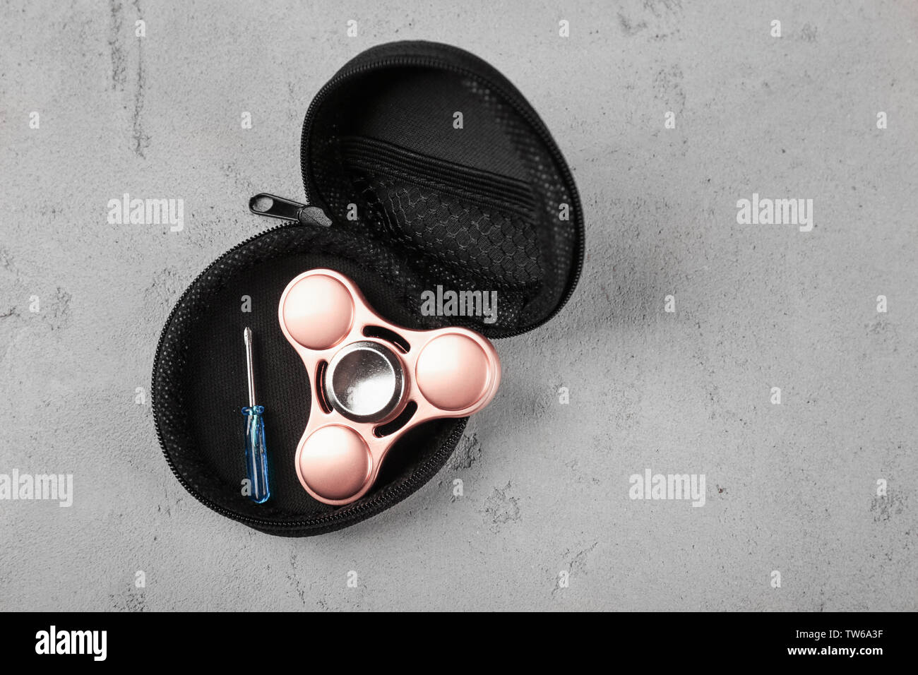 Modern spinner with screwdriver in black case on light background Stock ...