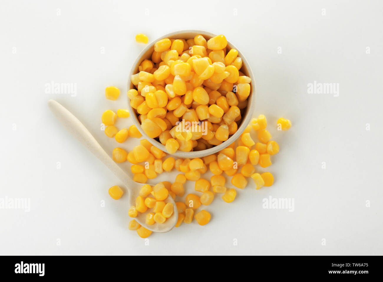 Bowl and canned corn kernels on white background Stock Photo - Alamy