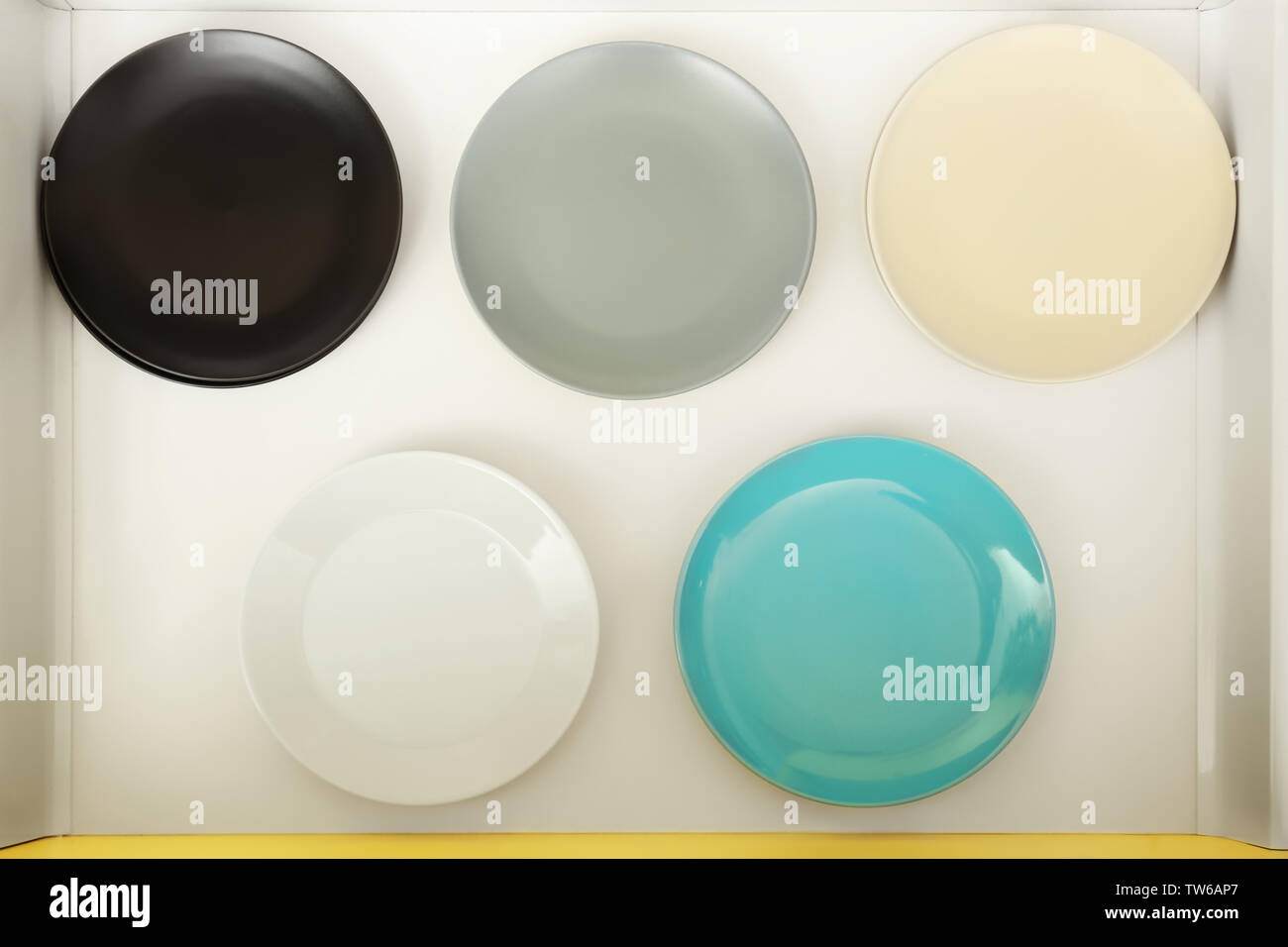 Set of ceramic plates in kitchen drawer Stock Photo - Alamy