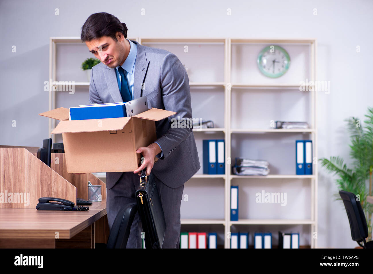 Young male employee being fired from his work Stock Photo - Alamy