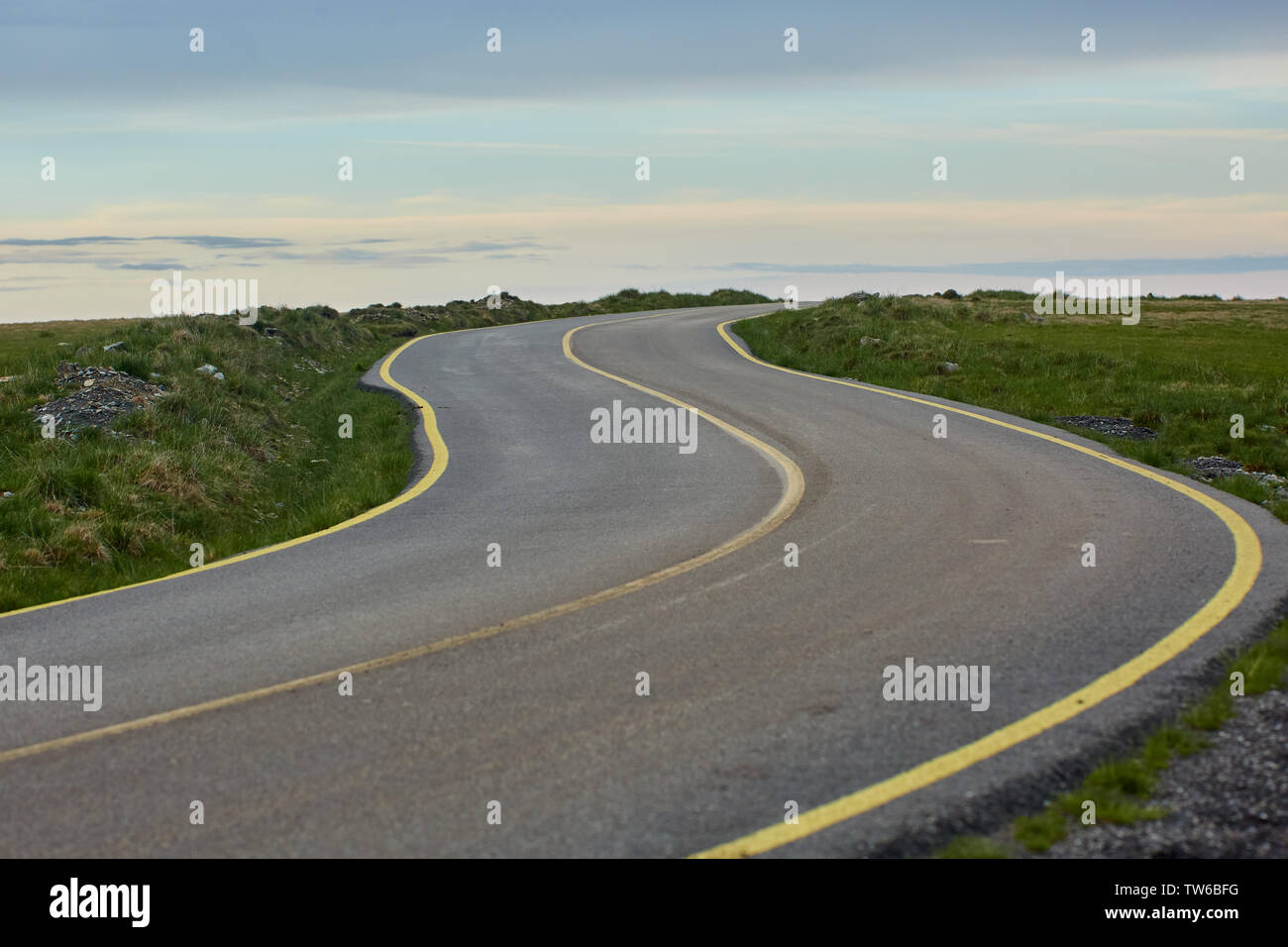 Landscape with winding road into the mountains Stock Photo - Alamy
