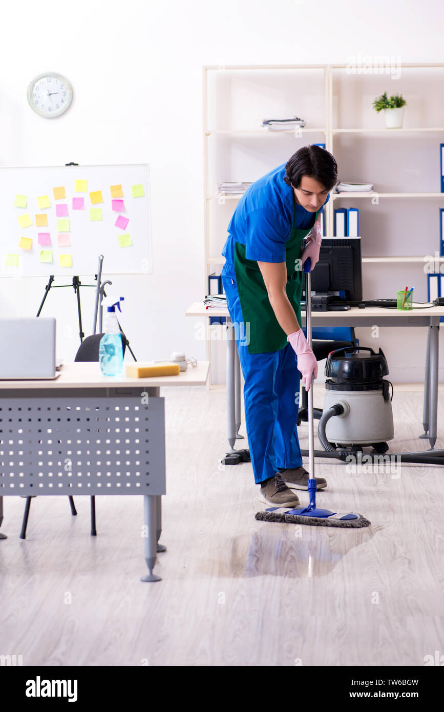 Male handsome professional cleaner working in the office Stock Photo ...