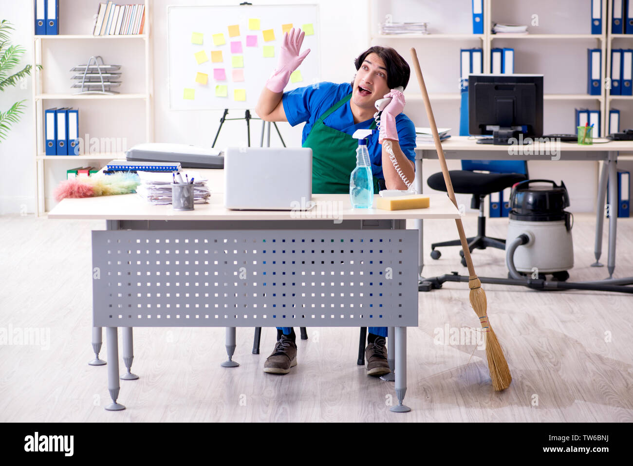 Male handsome professional cleaner working in the office Stock Photo ...