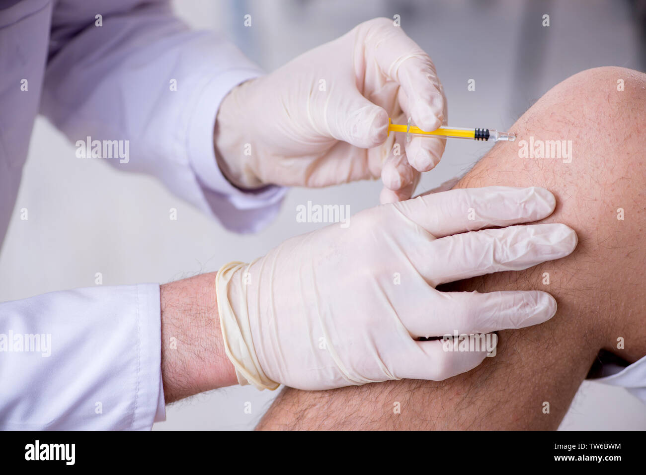Male patient visitng doctor for shot inoculation Stock Photo - Alamy