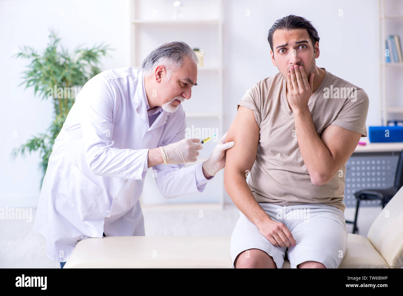 Male patient visitng doctor for shot inoculation Stock Photo - Alamy