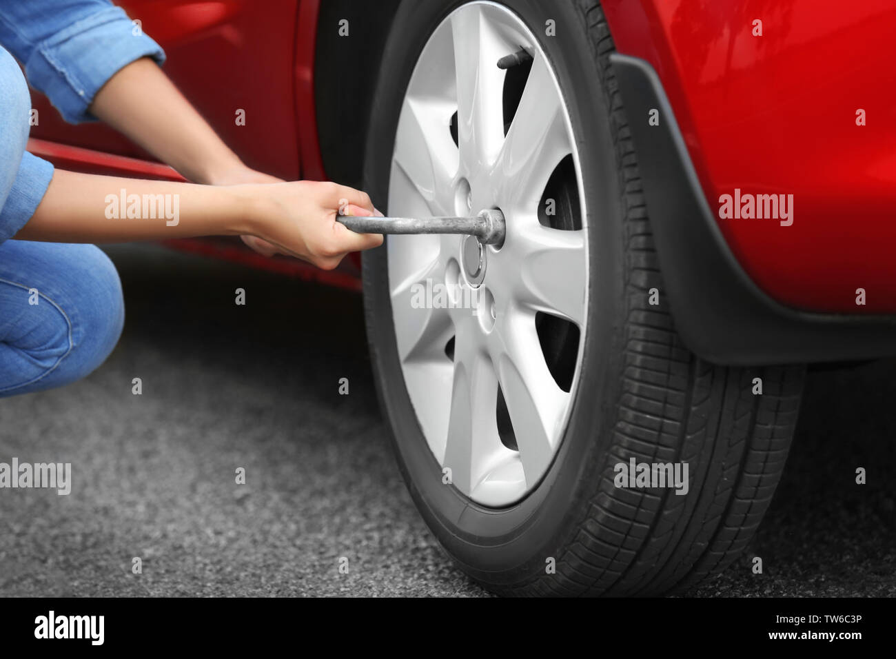 Woman changing wheel hi-res stock photography and images - Alamy