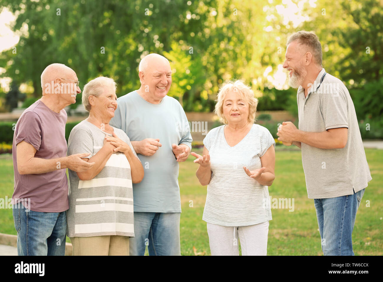 Group of elderly people resting in park Stock Photo - Alamy