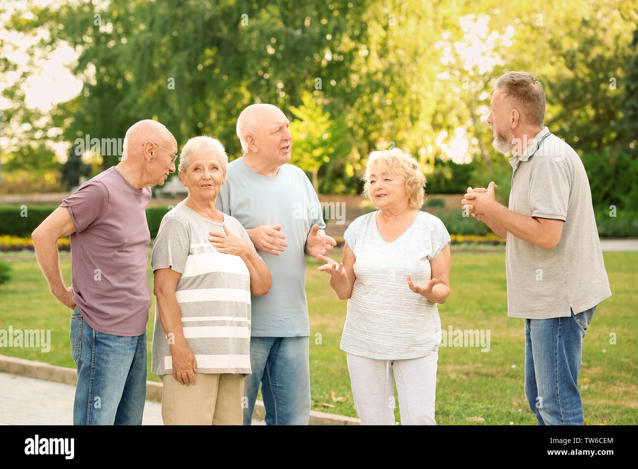 Group of elderly people resting in park Stock Photo - Alamy
