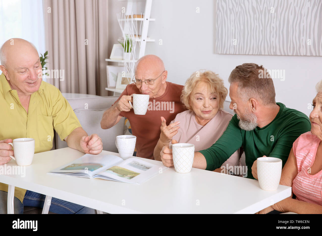 Group of elderly people resting at home Stock Photo - Alamy