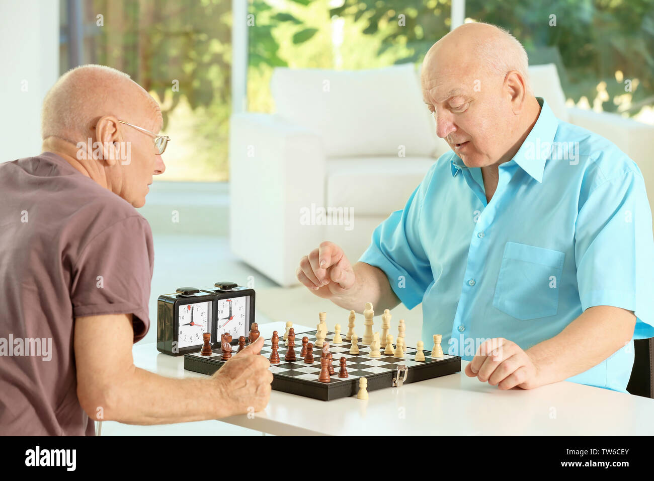 Elderly men playing chess at home Stock Photo - Alamy