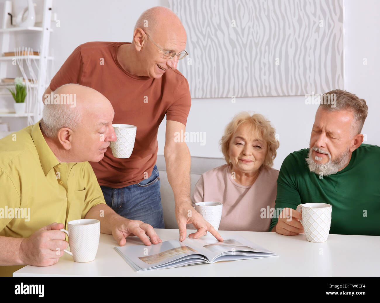 Group of elderly people resting at home Stock Photo - Alamy