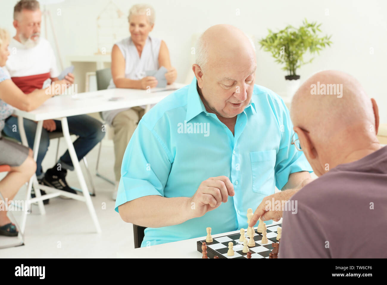 Elderly men playing chess at home Stock Photo - Alamy