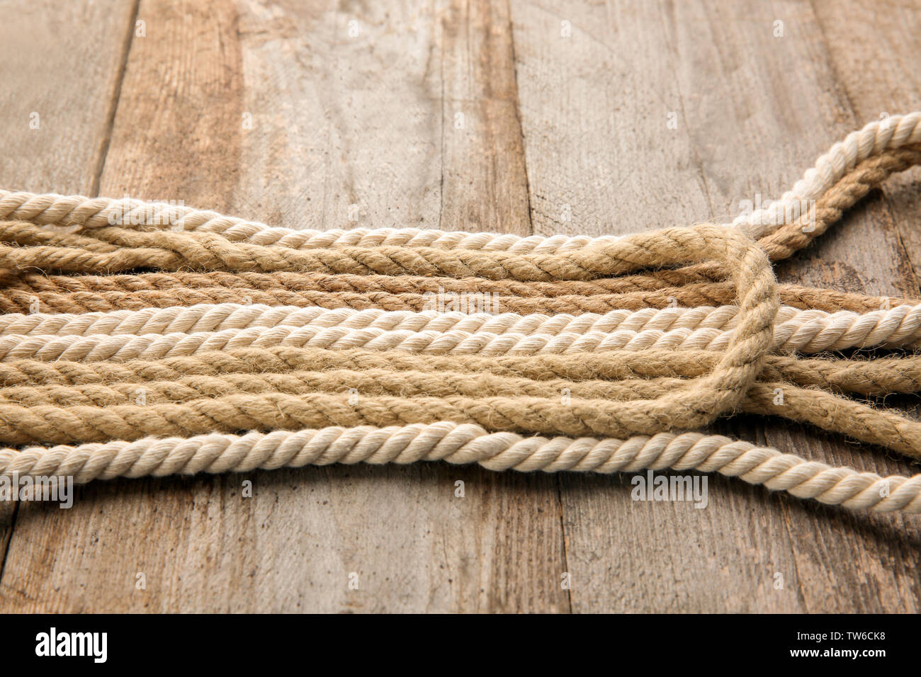Hemp ropes on wooden background Stock Photo - Alamy